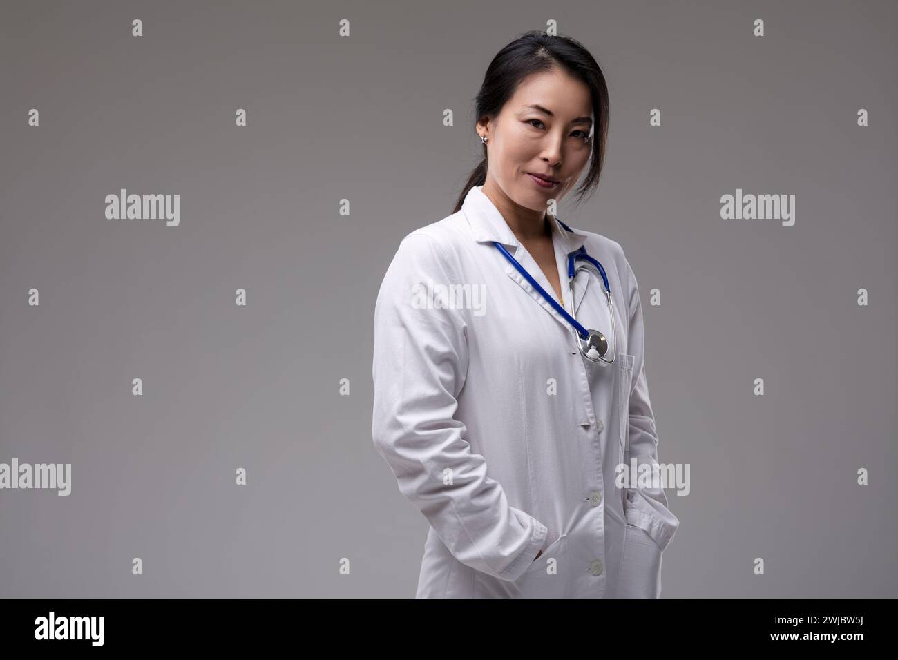 Confident medical professional stands poised, her expression calm and ...