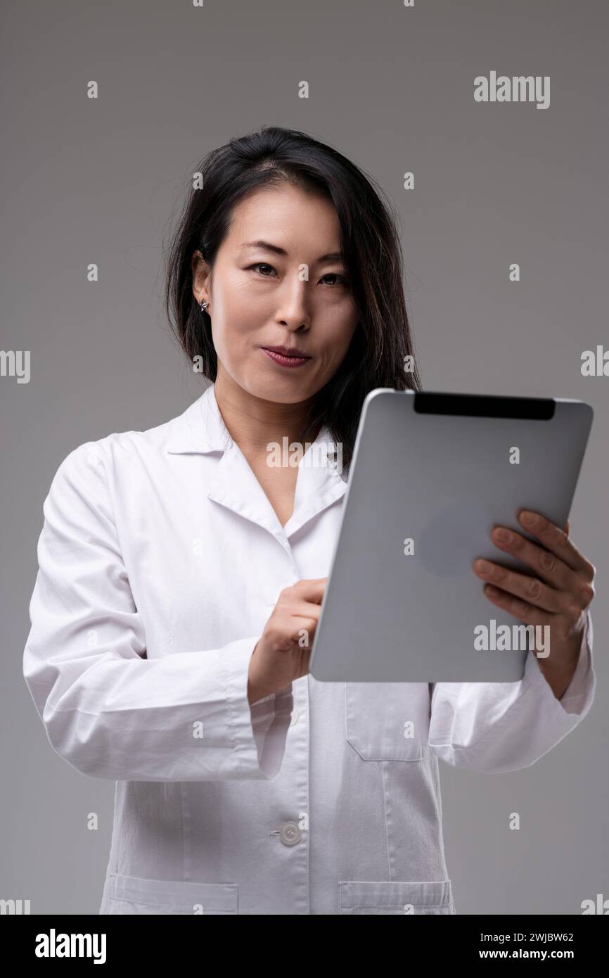 Doctor with a tablet likely navigates through patient information, a ...
