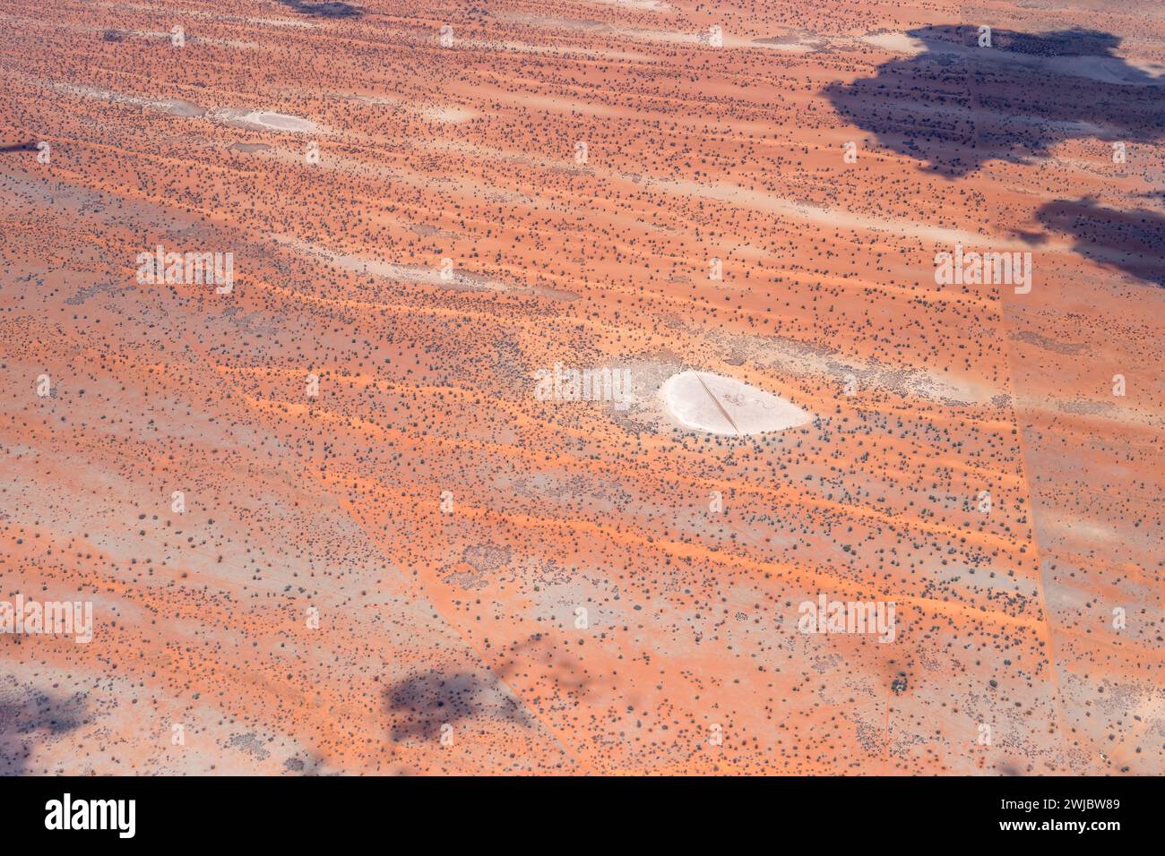 aerial landscape with little pan and red dune stripes in Kalahari ...
