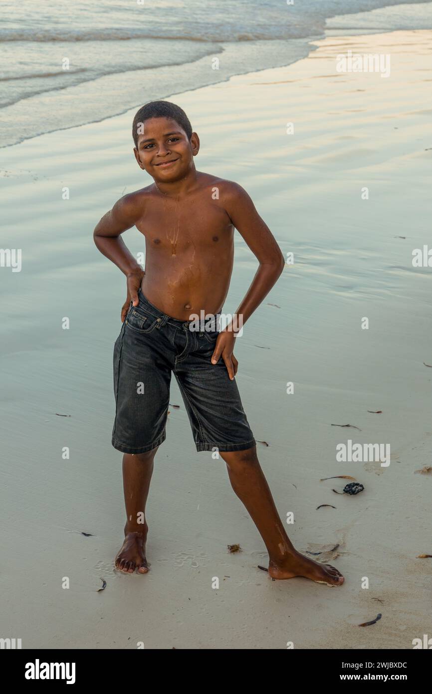 A young Dominican boy swims at the beach at Bahia de Las Galeras on the ...