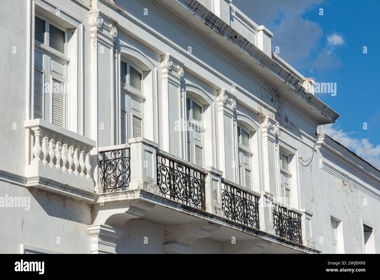 Wrought iron railings on a white building in the old historic Colonial ...