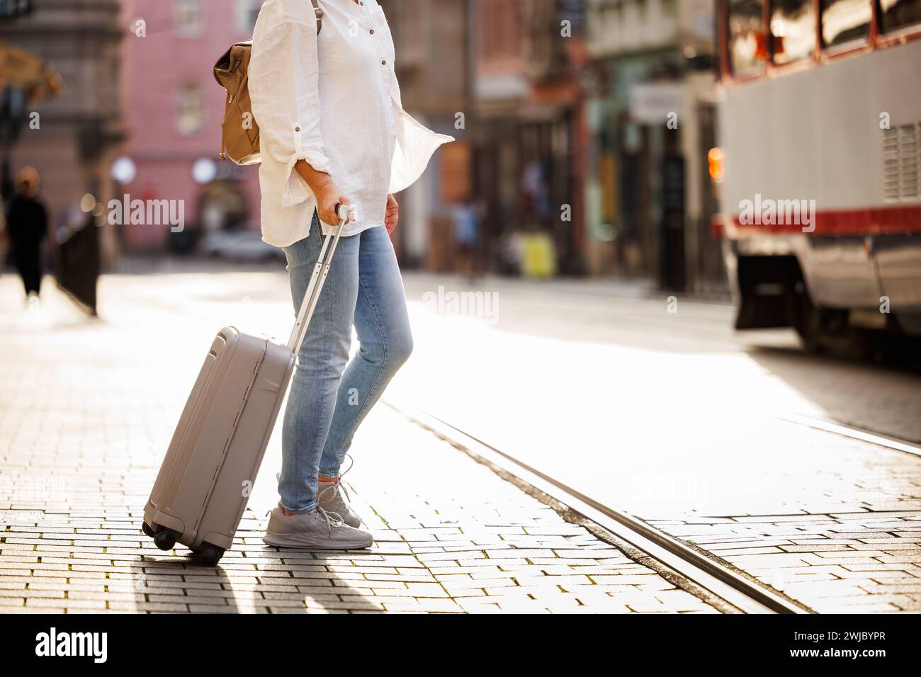Pulling woman on suitcase hi-res stock photography and images - Alamy