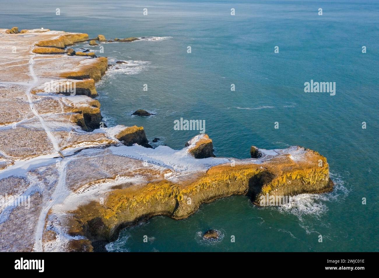 Aerial view over volcanic basalt cliff near Arnarstapi on the southern ...