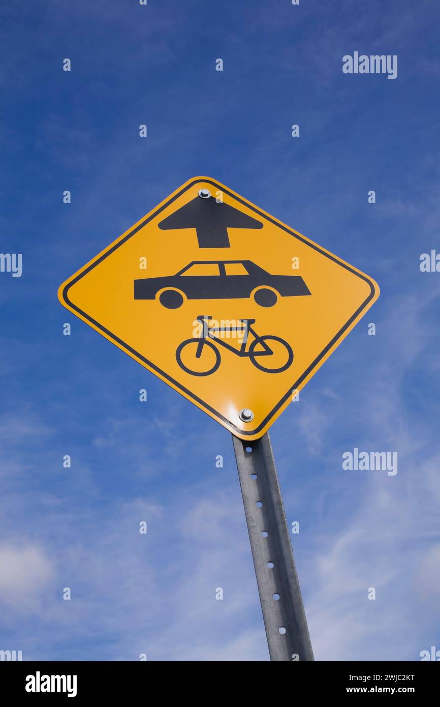 Yellow traffic pictogram sign with black painted car, bicycle and ...