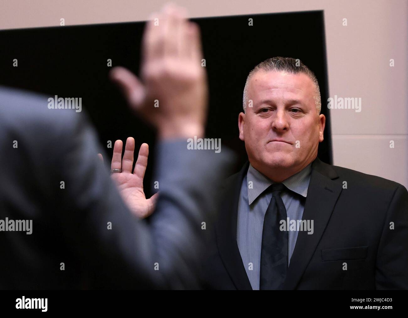 Scott Riley, right, is sworn in before he testifies at the trial of ...