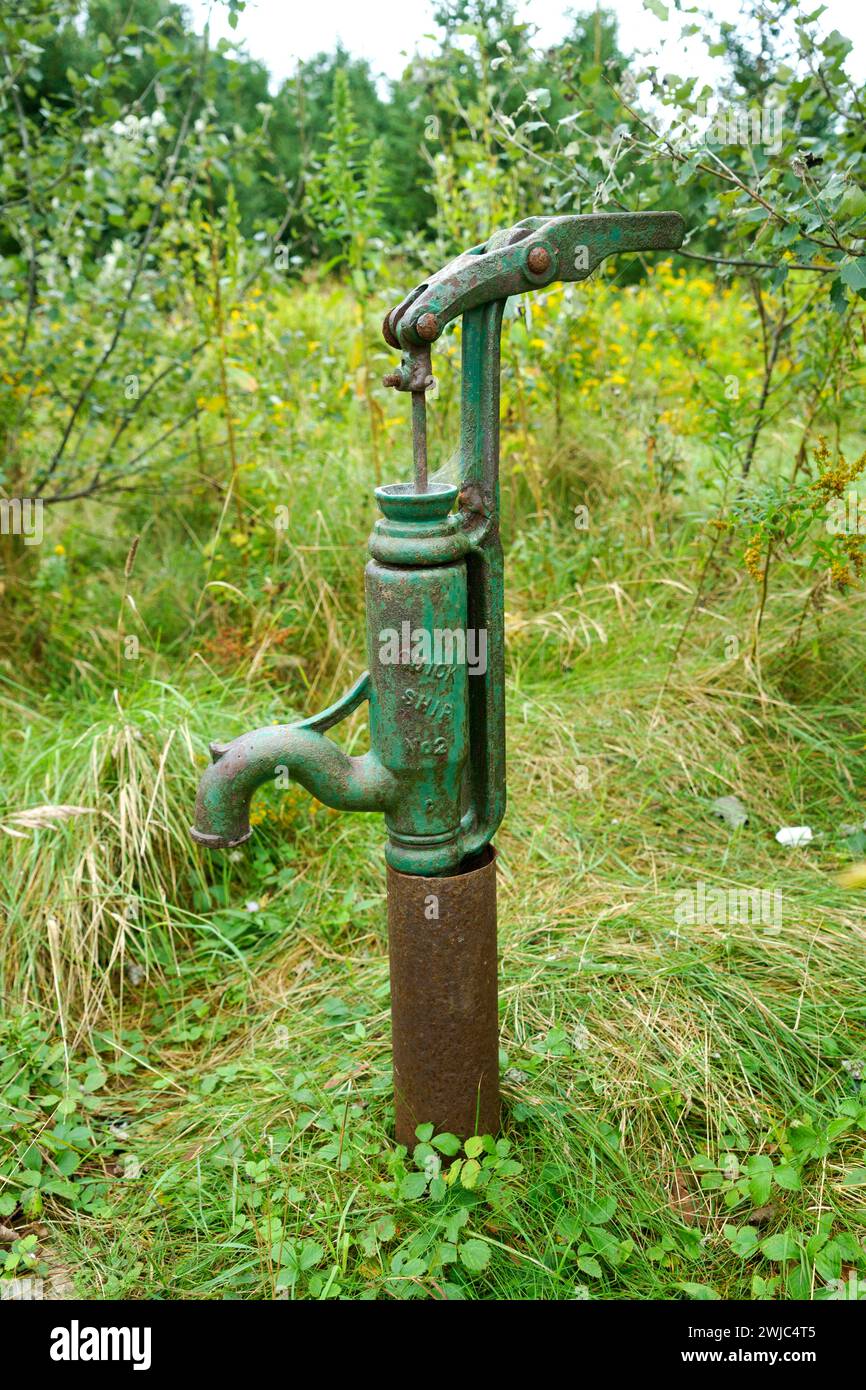 Old water hand pump on the grounds of an abandoned house in Rustico ...