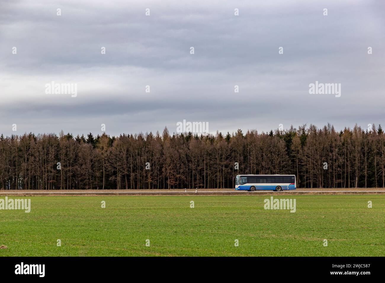 Bus on a country road in a rural landscape. Early springtime Stock ...