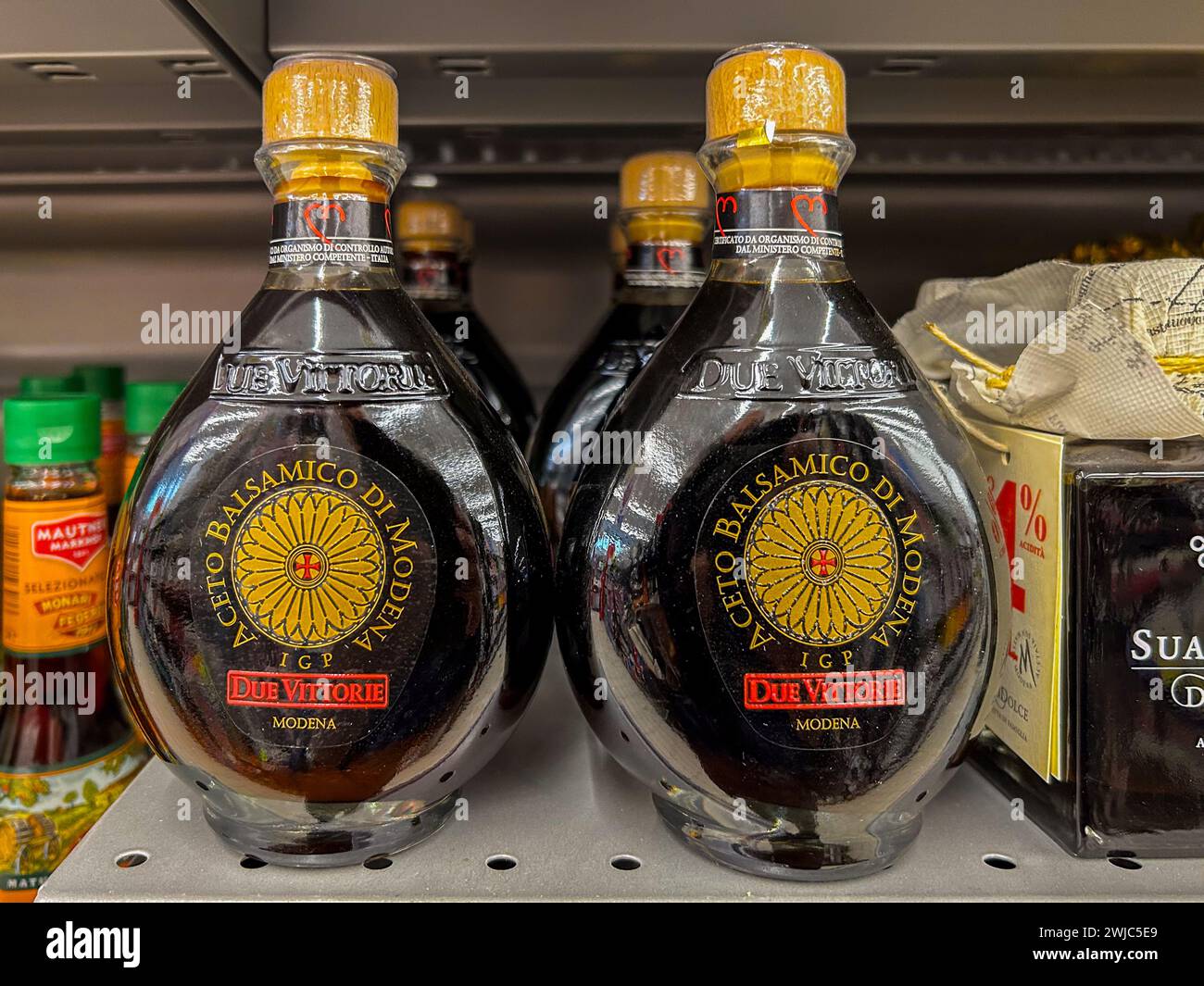 Italy - February 06, 2024: Balsamic Vinegar of Modena in glass bottles ...