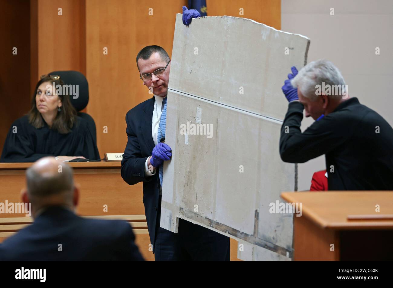 Manchester Police Department Detective Ray Lamy, center, holds evidence ...