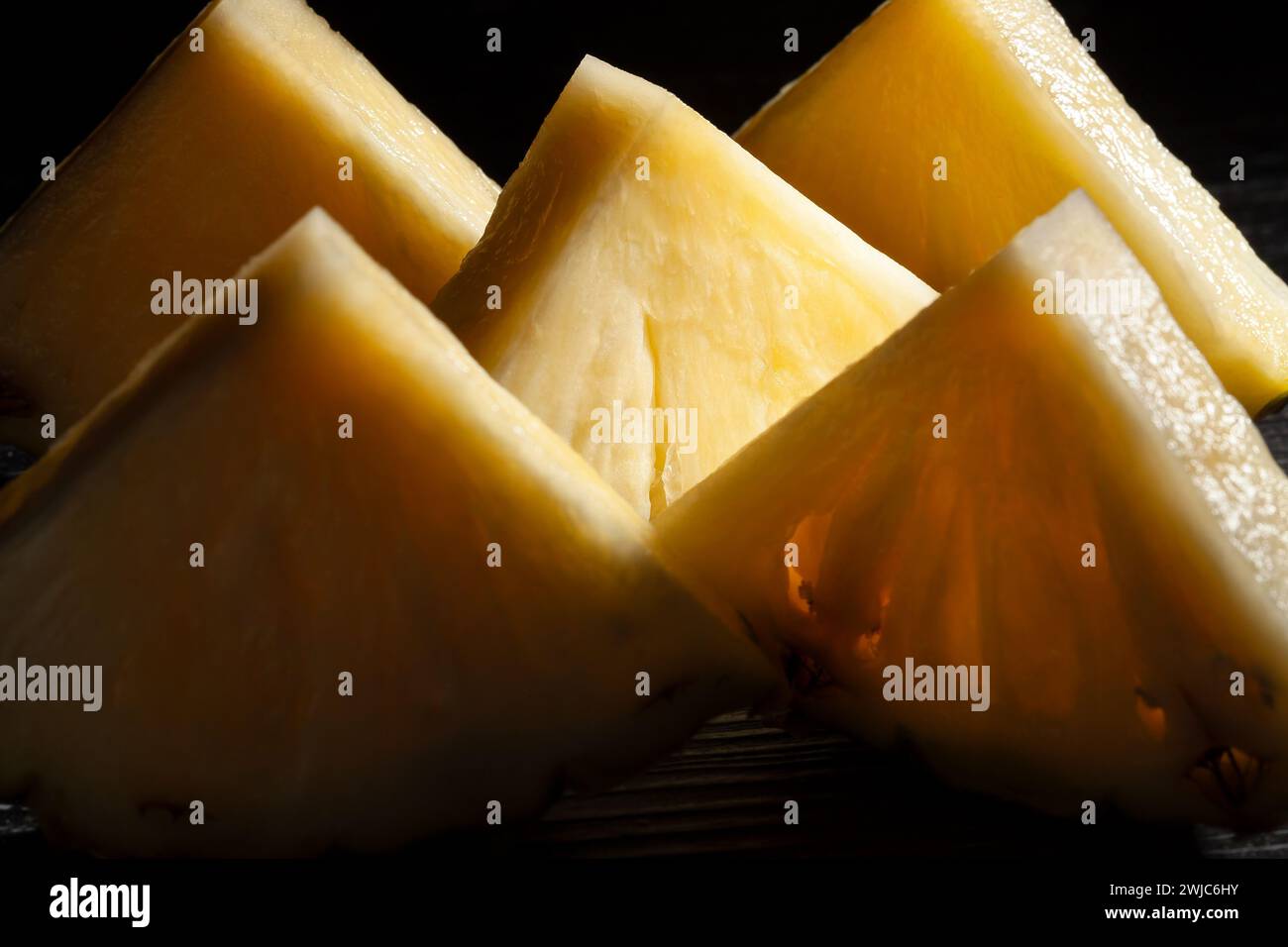 pineapple group on black background Stock Photo - Alamy