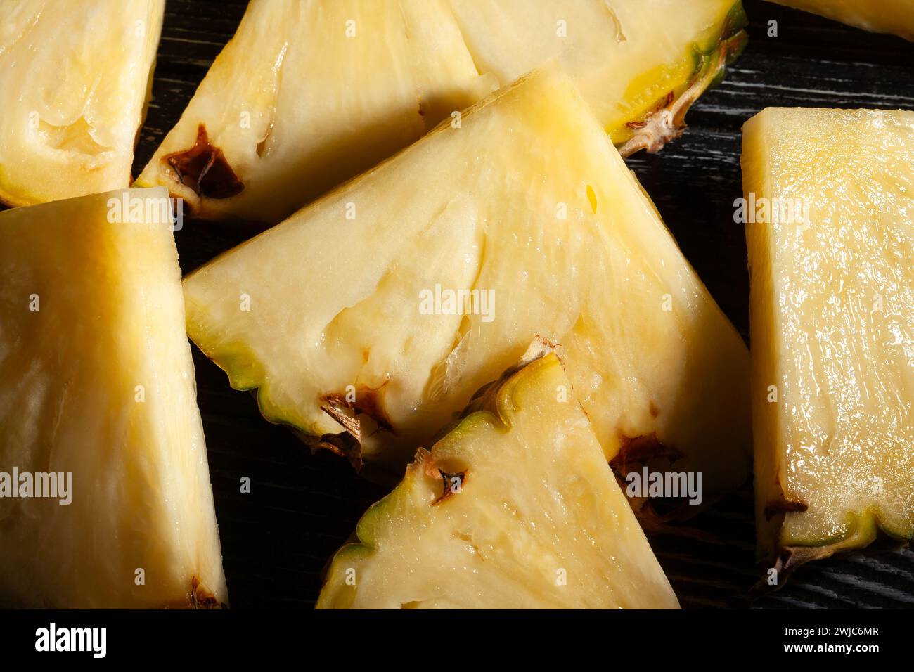 pineapple group on black background Stock Photo - Alamy