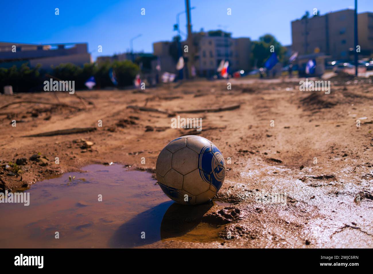 A soccer ball left in the dirt of Sderot, Southern Israel, in the ...