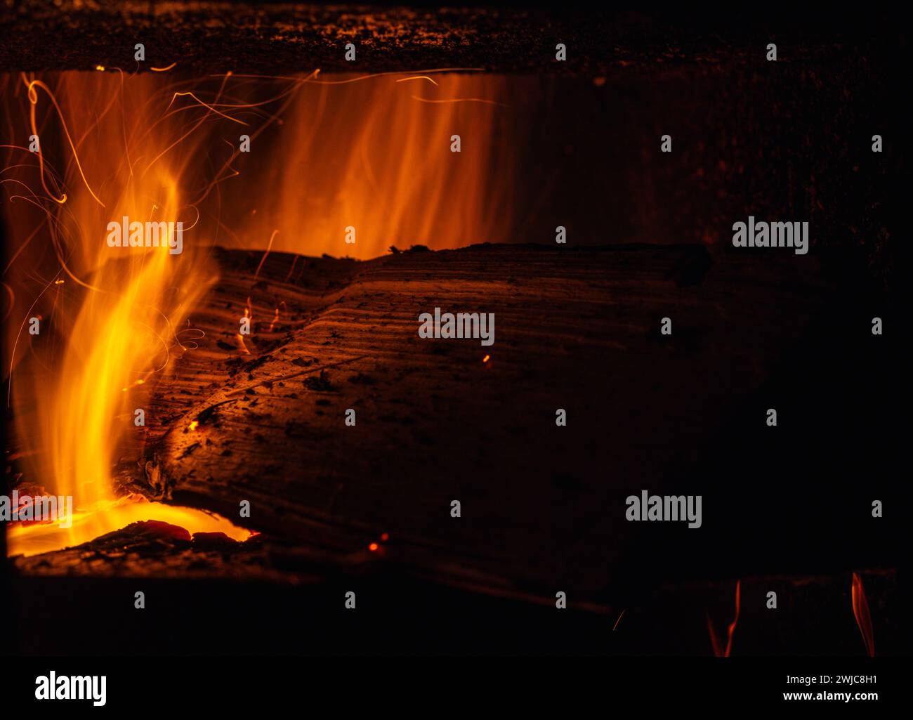 Close-up of soot particles and the trajectory of sparks from burning a ...
