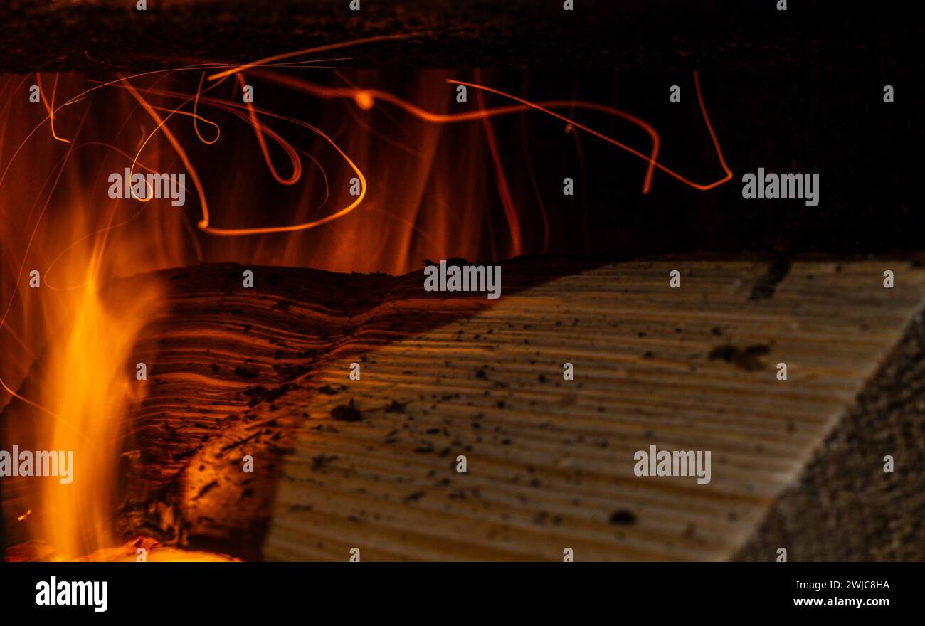 Trajectory of burning log particles in a rustic stove Stock Photo - Alamy