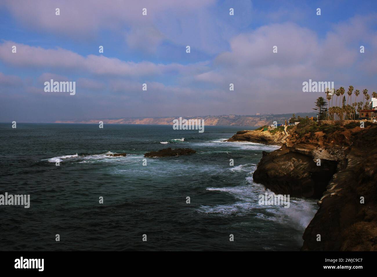 A breathtaking coastal landscape featuring a majestic cliff, sandy ...