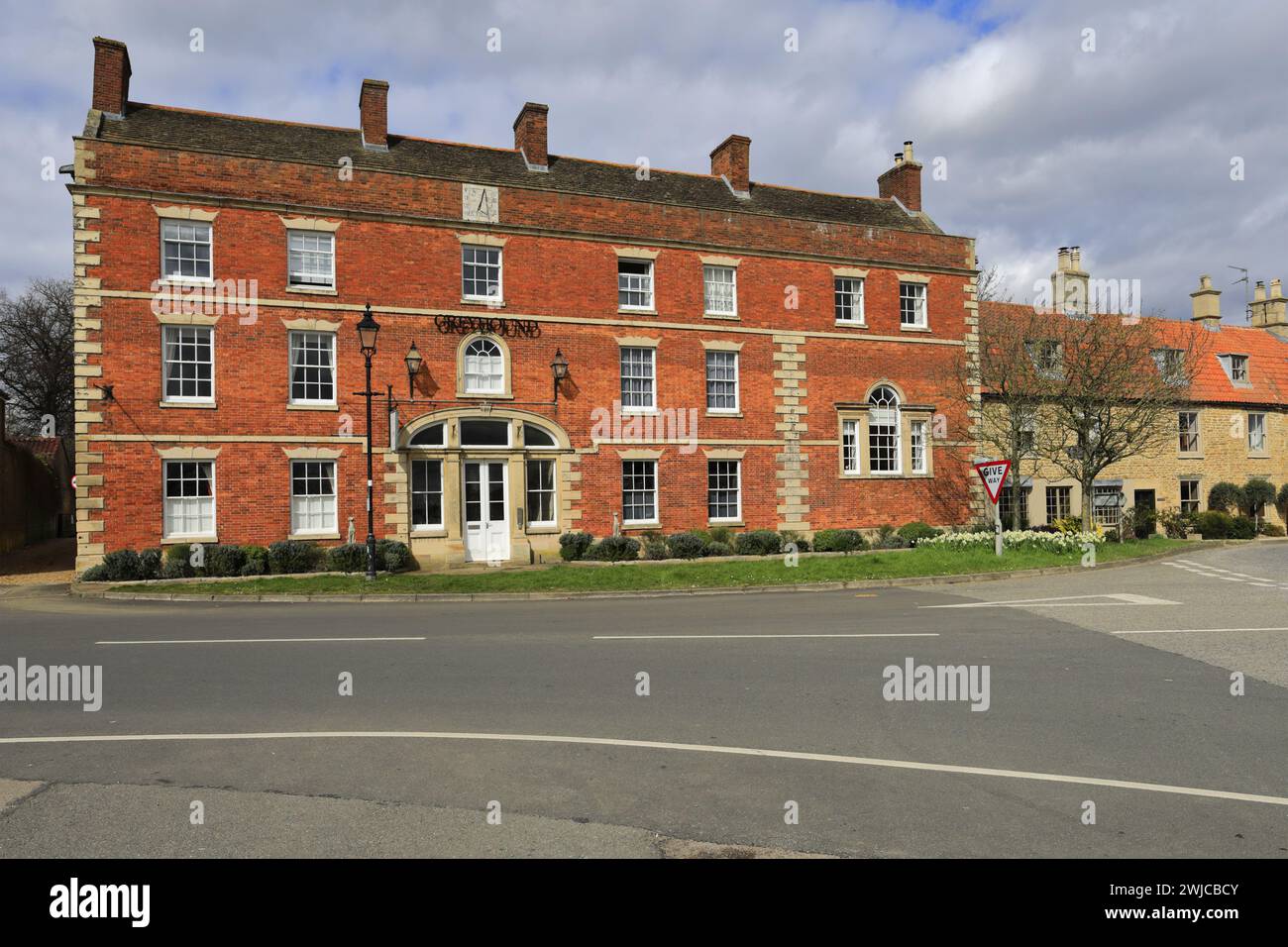 Spring Daffodils around the buildings of Folkingham village green ...