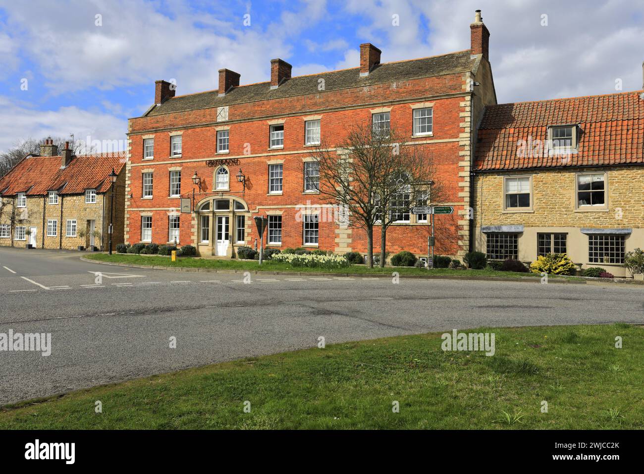 Spring Daffodils around the buildings of Folkingham village green ...