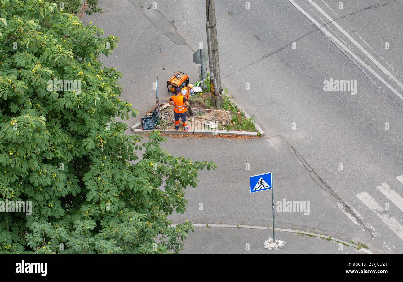 Workers installers are installing a new street lamp and dismantling the ...