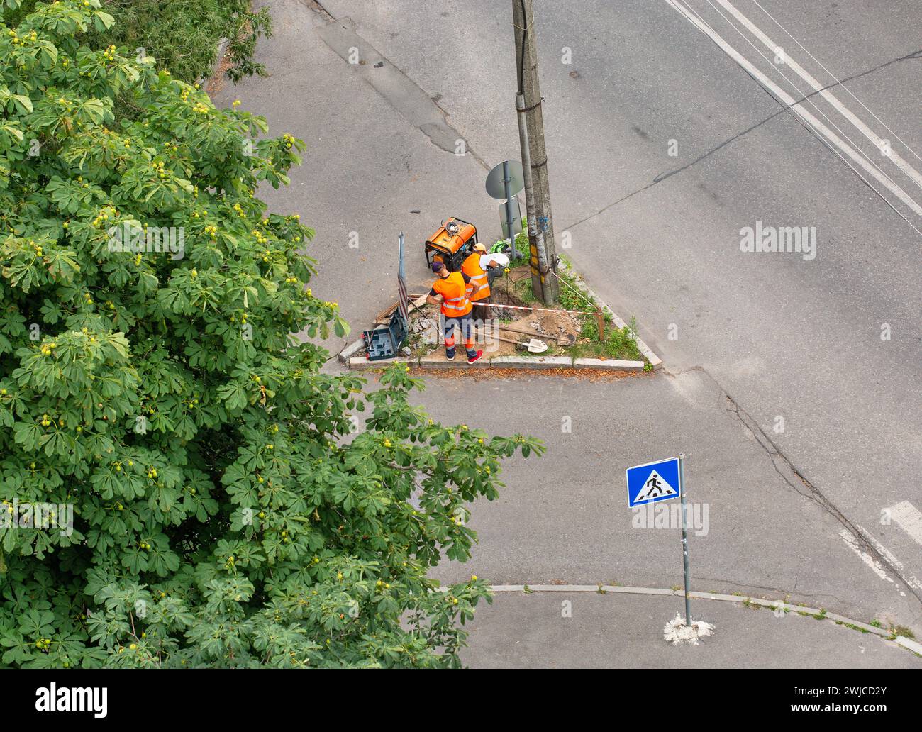 Workers installers are installing a new street lamp and dismantling the ...