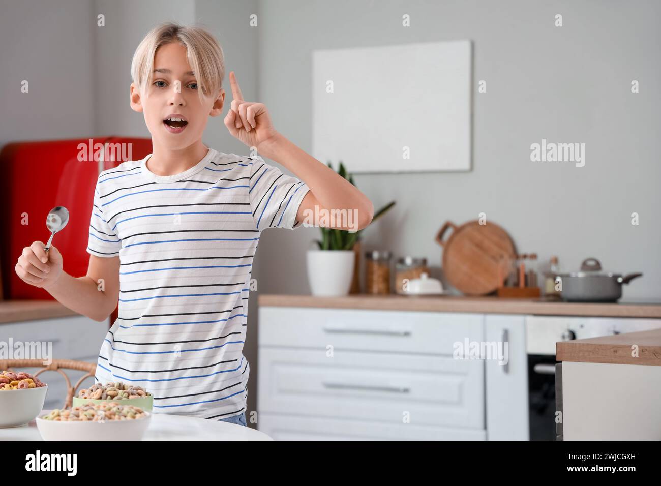 Shocked little boy with cereal rings at home Stock Photo - Alamy