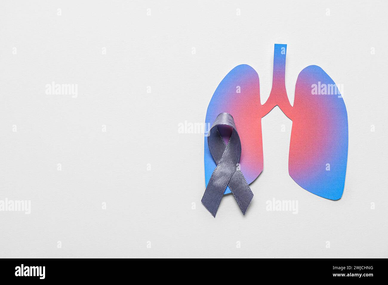 Paper lungs with ribbon on grey background Stock Photo - Alamy