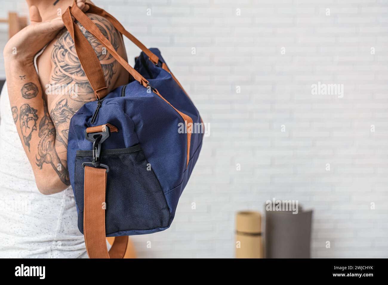 Young man with sports bag in gym Stock Photo - Alamy