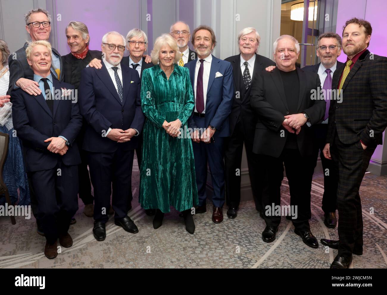 Britain's Queen Camilla, centre, smiles as she poses with actors from ...