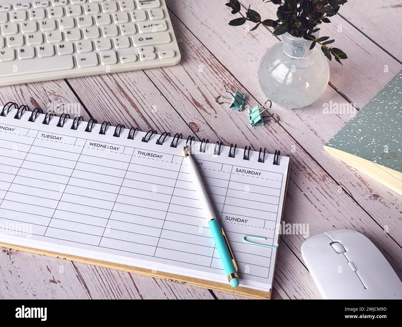 A Desk With a Blank Weekly Planner, Keyboard, Mouse, and a Notebook ...