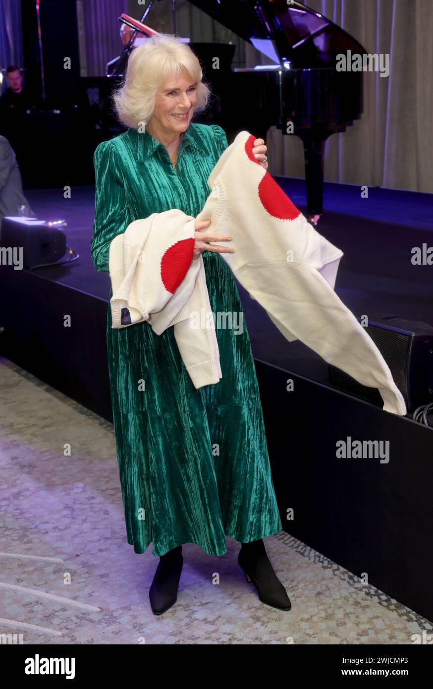 Queen Camilla smiles as she holds gifts of Valentine's Day jumpers with ...
