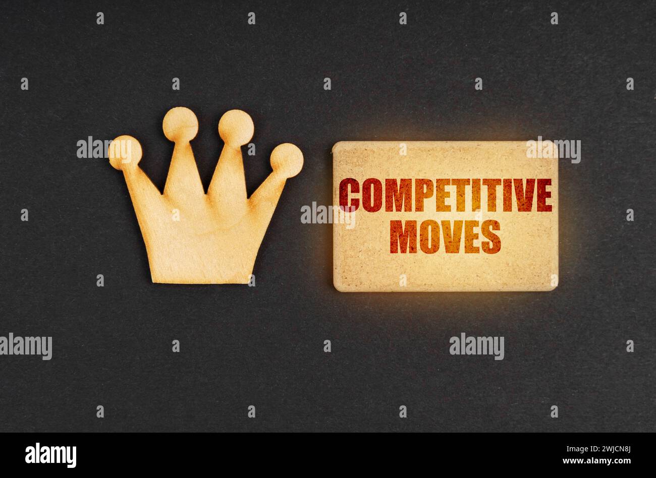 Business concept. On a black background there is a wooden crown of the ...