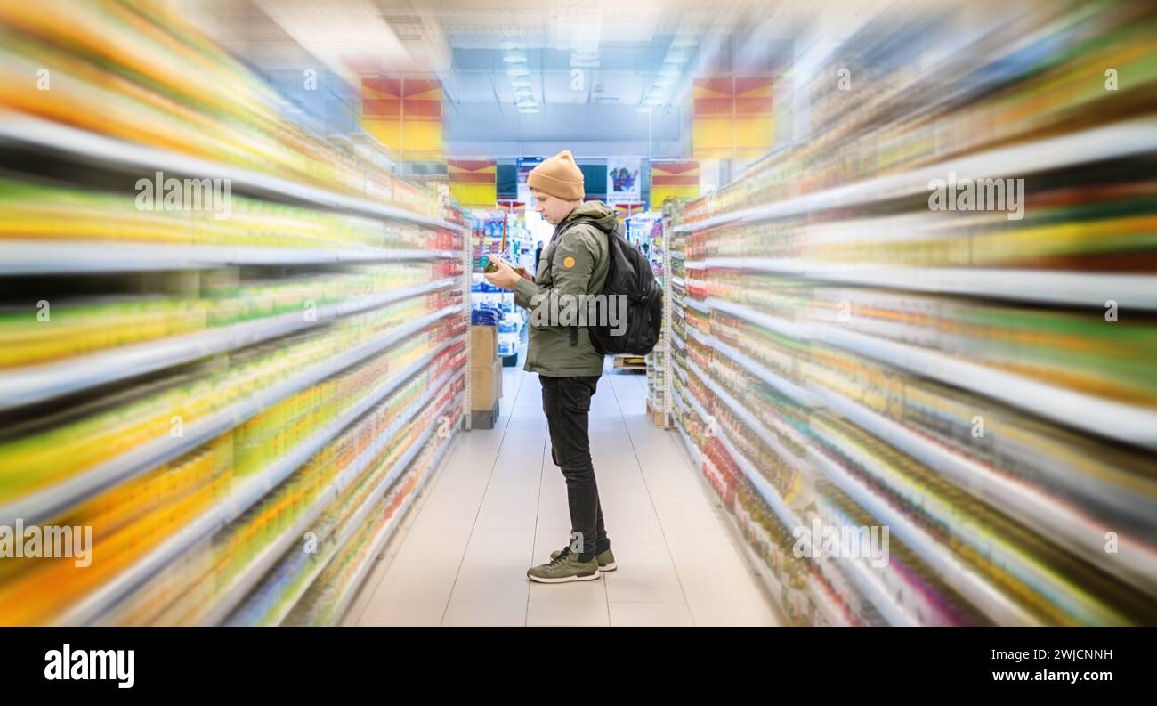 Customer choose food items on supermarket shelves in grocery store ...