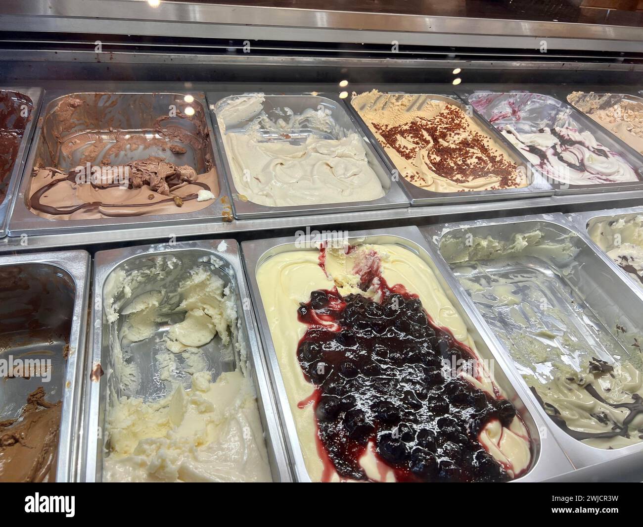 Showcase of an ice cream parlor with various flavors of ice cream ...