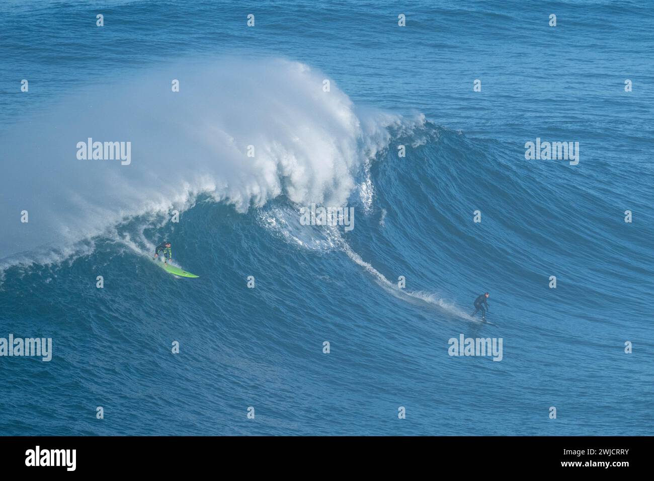 Two surfers ride wave hi-res stock photography and images - Alamy