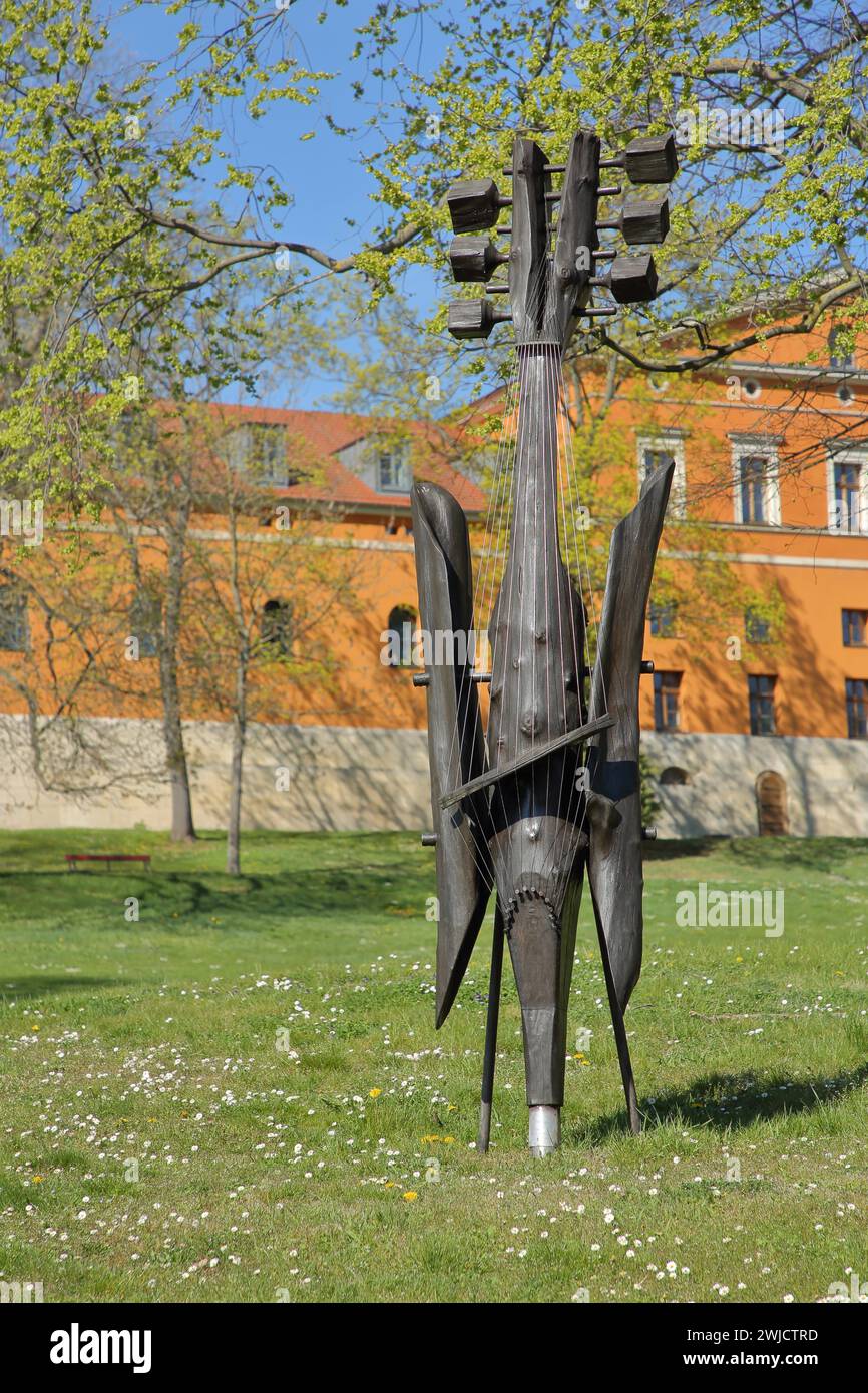 Sculpture with stringed instrument, violin, viola, cello in front of ...
