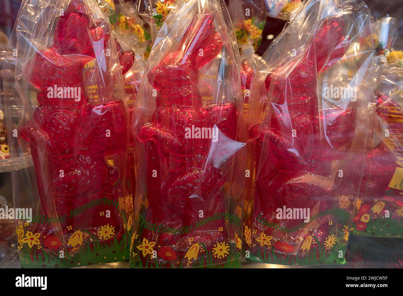 Red rabbit figurines wrapped in cellophane, in the shop window of a ...