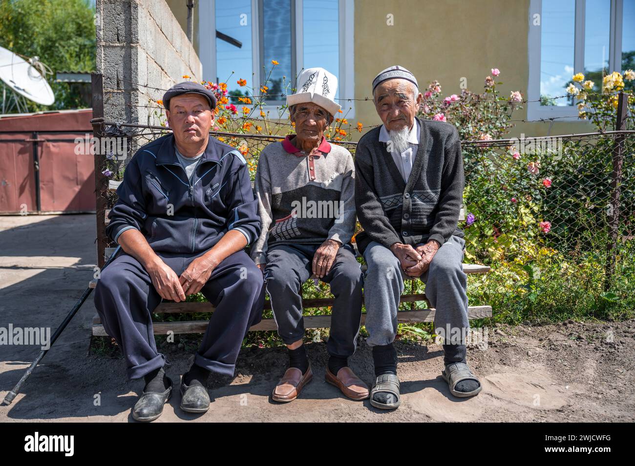 Three local elderly men on a bench, Issyk-Kul region, Kyrgyzstan Stock ...