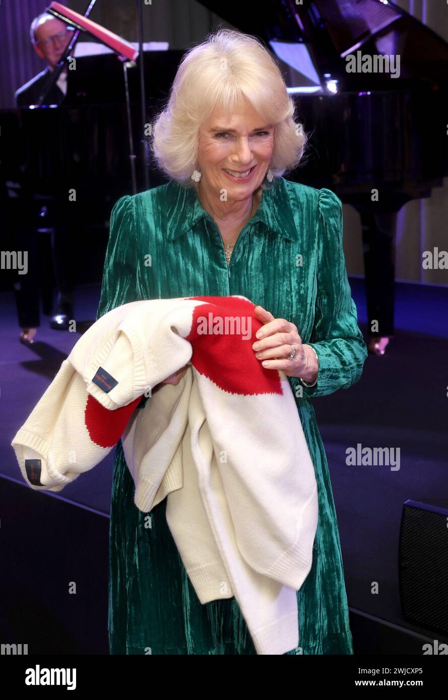 Queen Camilla smiles as she holds gifts of Valentine's Day jumpers with ...