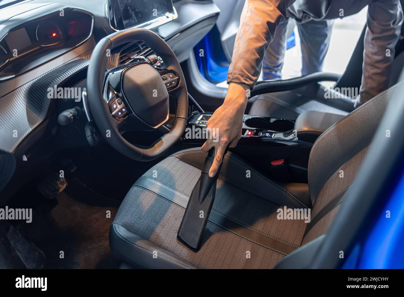 Car interior luxury service. Details of car cleaning male using ...