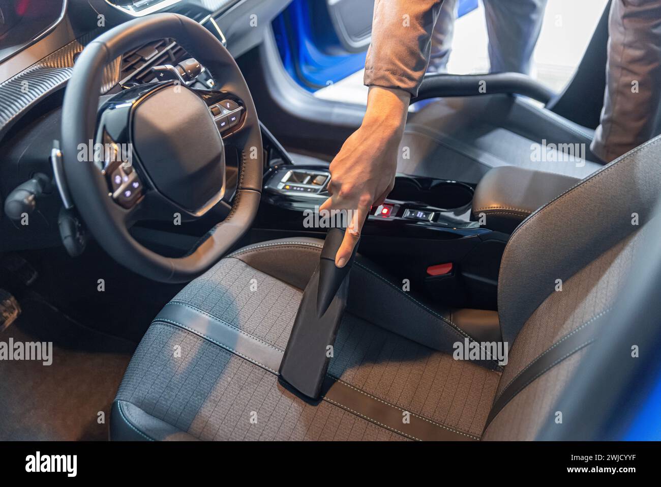 Car interior luxury service. Details of car cleaning male using ...