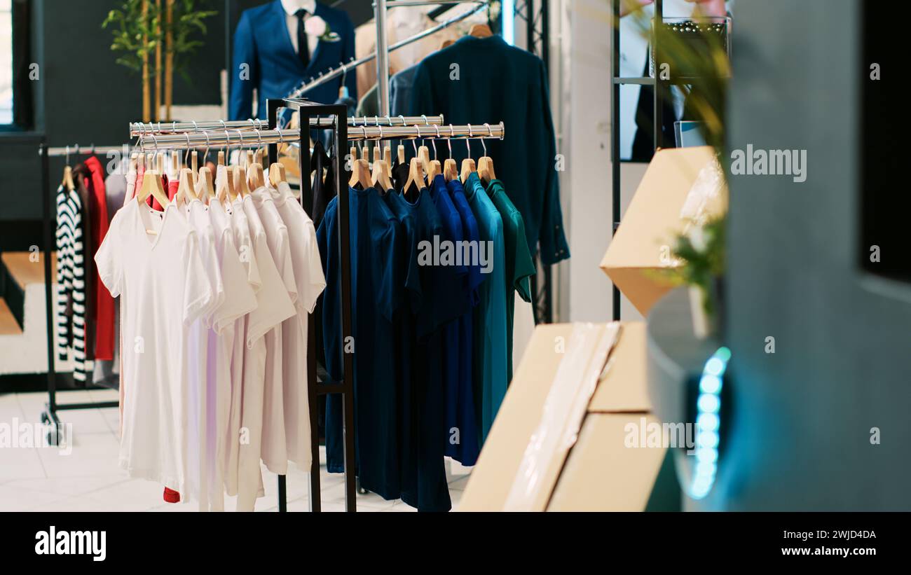 Empty modern boutique with casual and formal wear items, retail shop ...