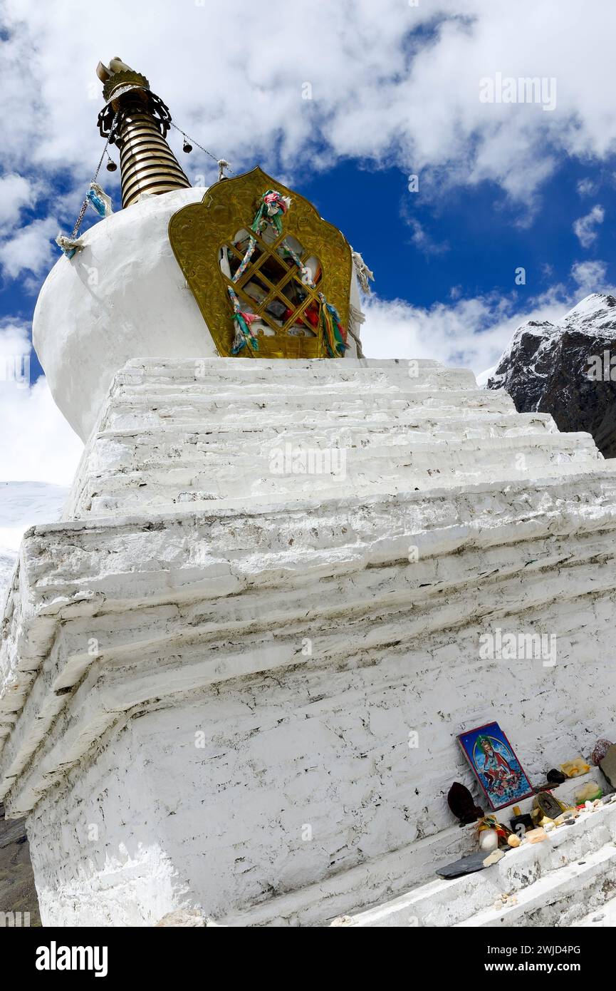 A Buddhist stupa sits in front of the Karo-La Glacier at an altitude of ...