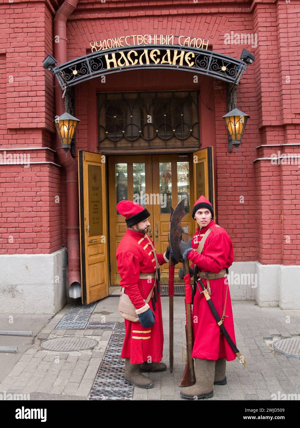 Two men dressed in traditional costumes outside a restaurant in Moscow ...
