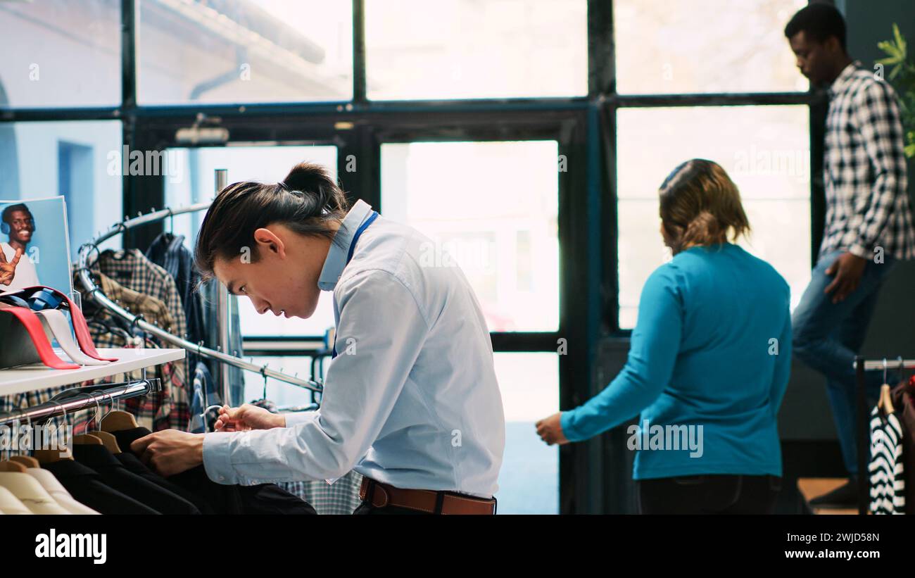 Worker arranging stylish clothes hi-res stock photography and images ...
