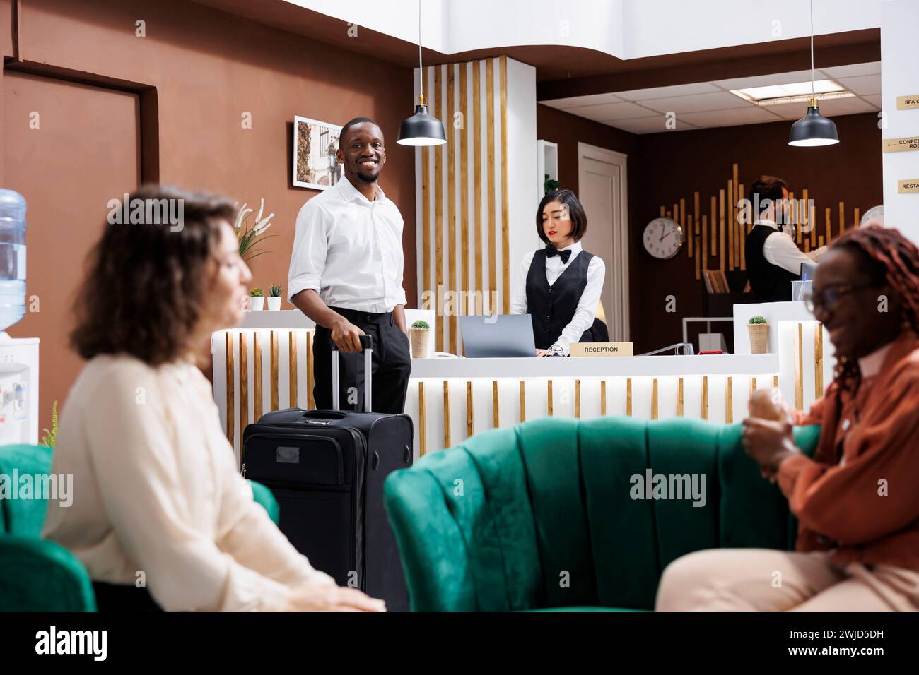 African american guest arriving at hotel, waiting to receive access key ...