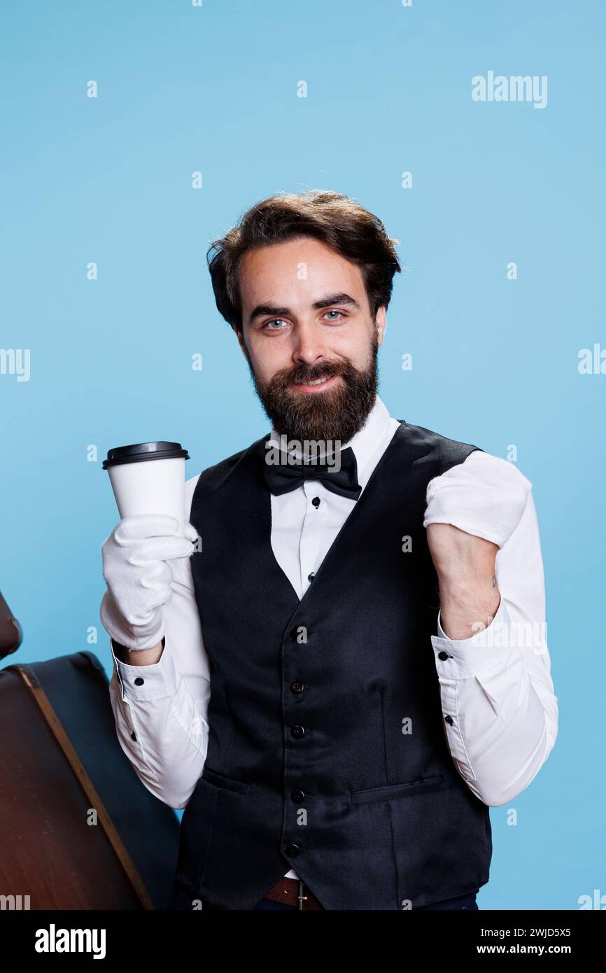 Confident doorman feeling happy in studio, holding cup of coffee ...