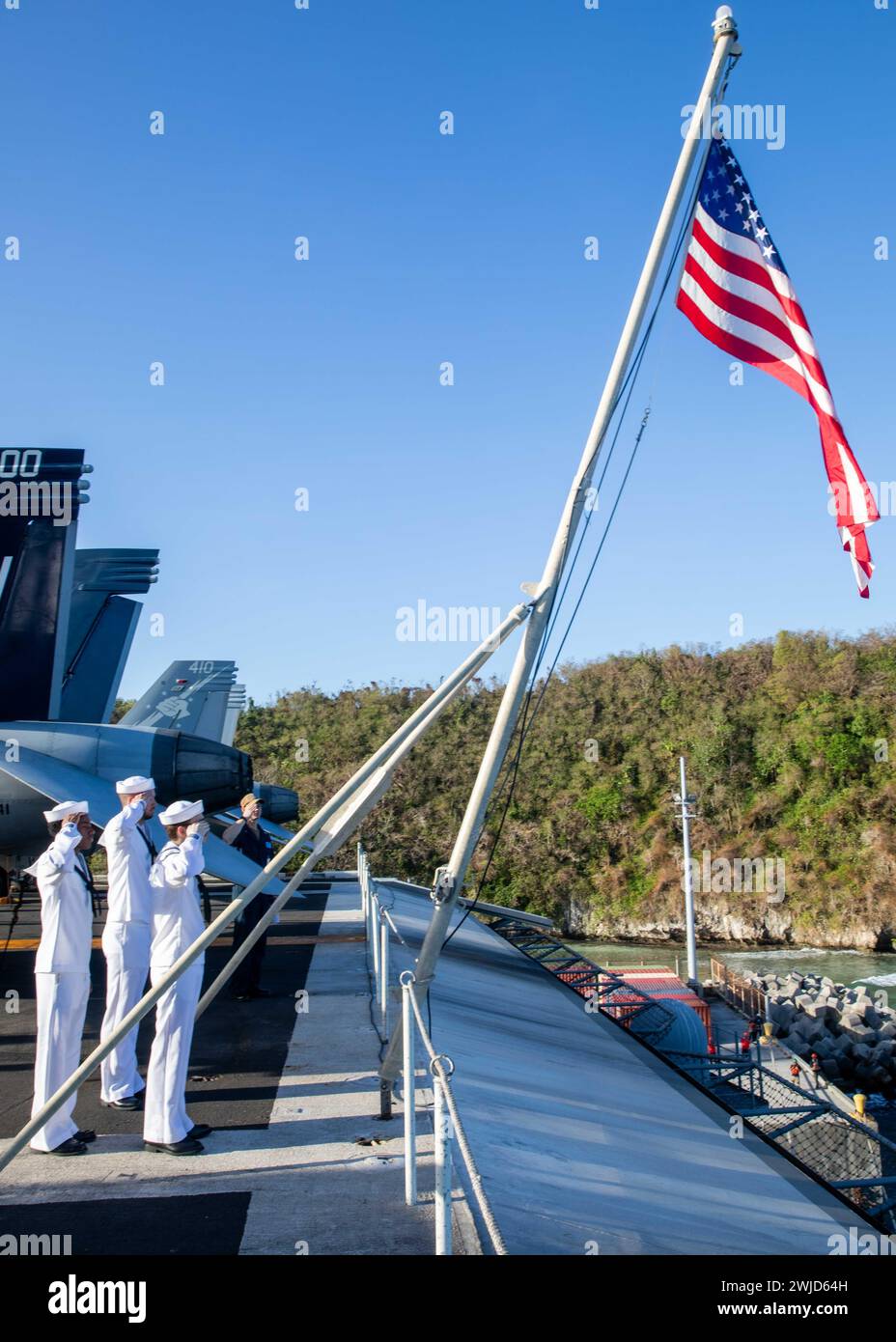 APRA HARBOR, Guam (Feb. 14, 2024) U.S. Sailors salute the U.S. flag ...