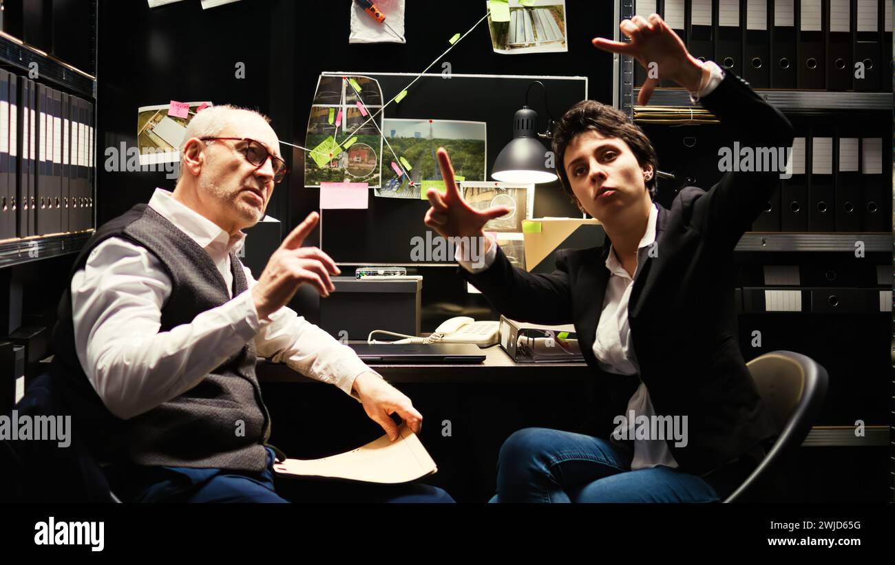 Partners reviewing AR hologram, analyzing surveillance footage on ...