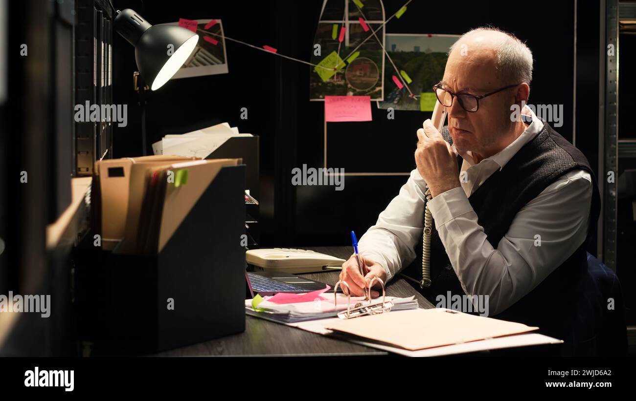 Private detective answering phone call to find out about forensic ...