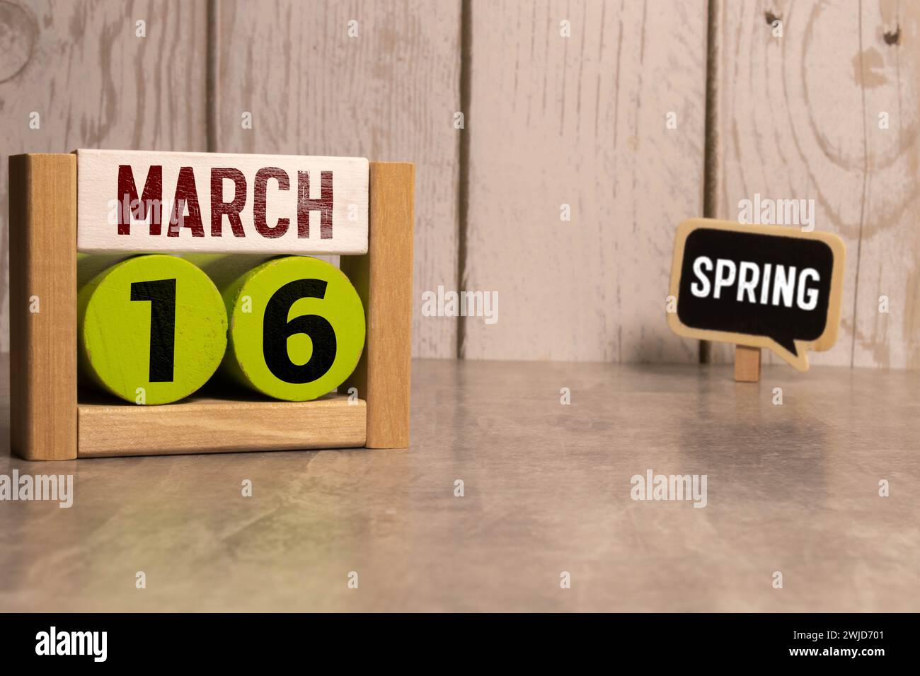 March 16 calendar date text on wooden blocks with blurred park ...