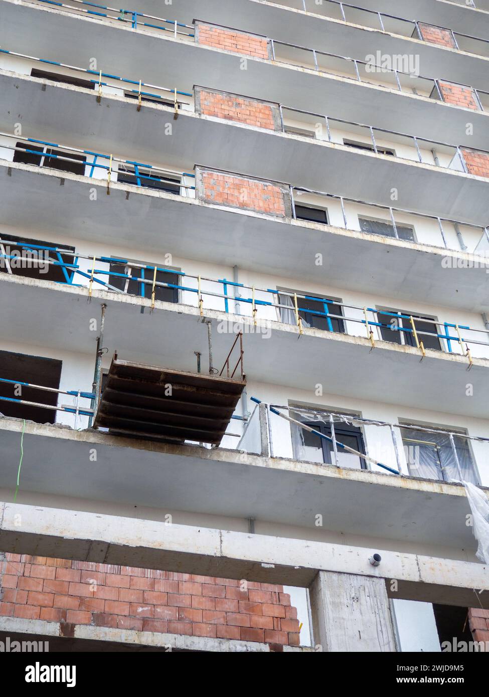 facade of an unfinished high-rise building. panel house. Balconies of a ...